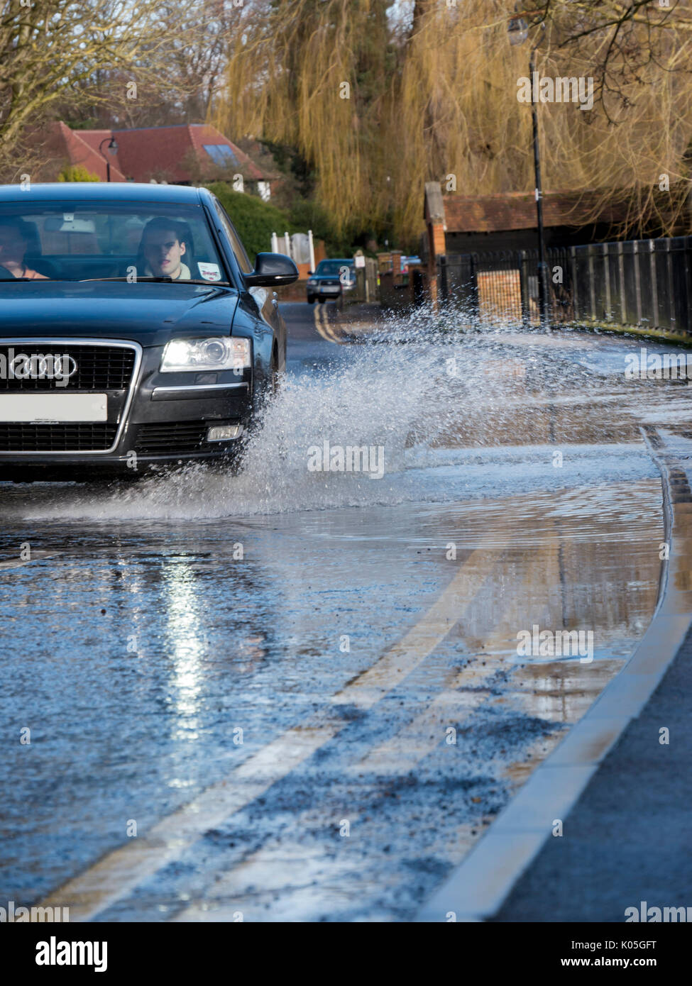 UK, Surrey, Cobham, flood water on road splash Stock Photo - Alamy