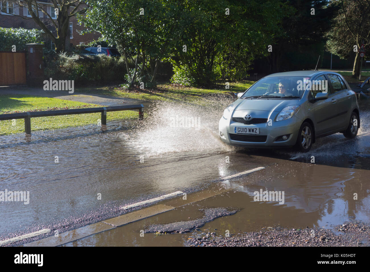 UK, Surrey, Cobham, flood water on road splash Stock Photo - Alamy