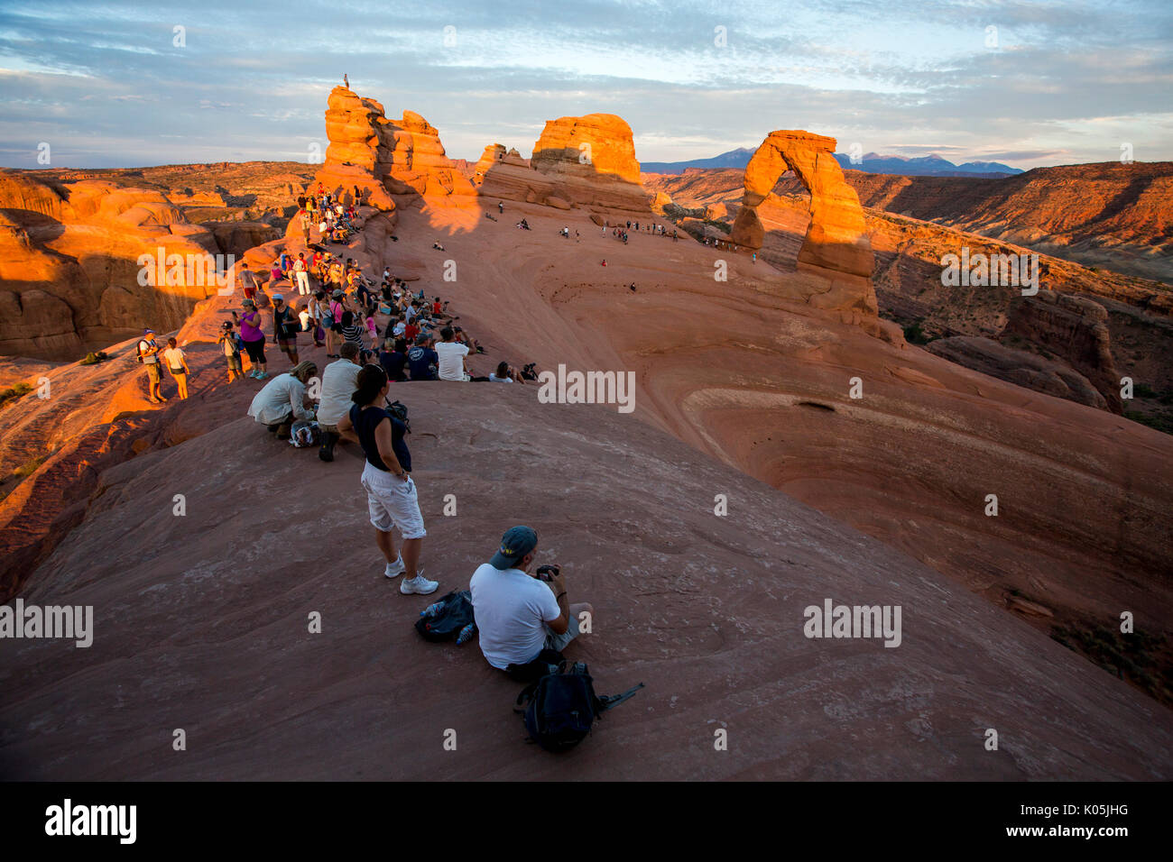Tourists at Delicate Arch in Arches National Park, Canyon lands ...