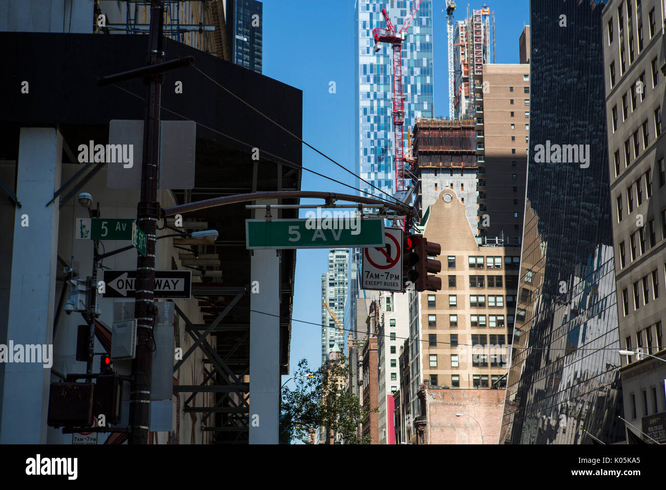 New York city street scene with traffic lights hanging overhead from ...