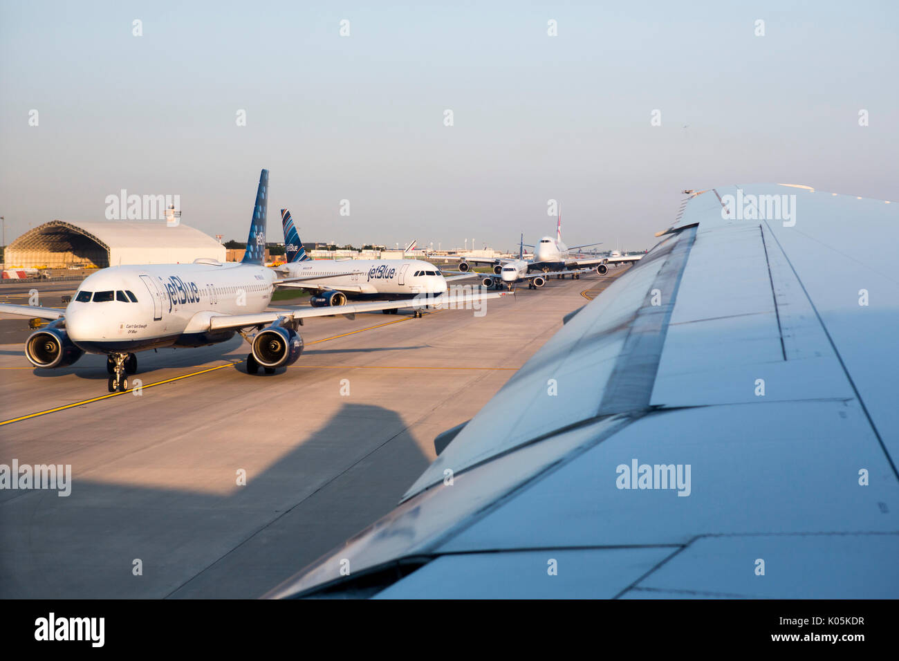 Aeroplanes line up for take off on the runways at JFK airport, New York ...
