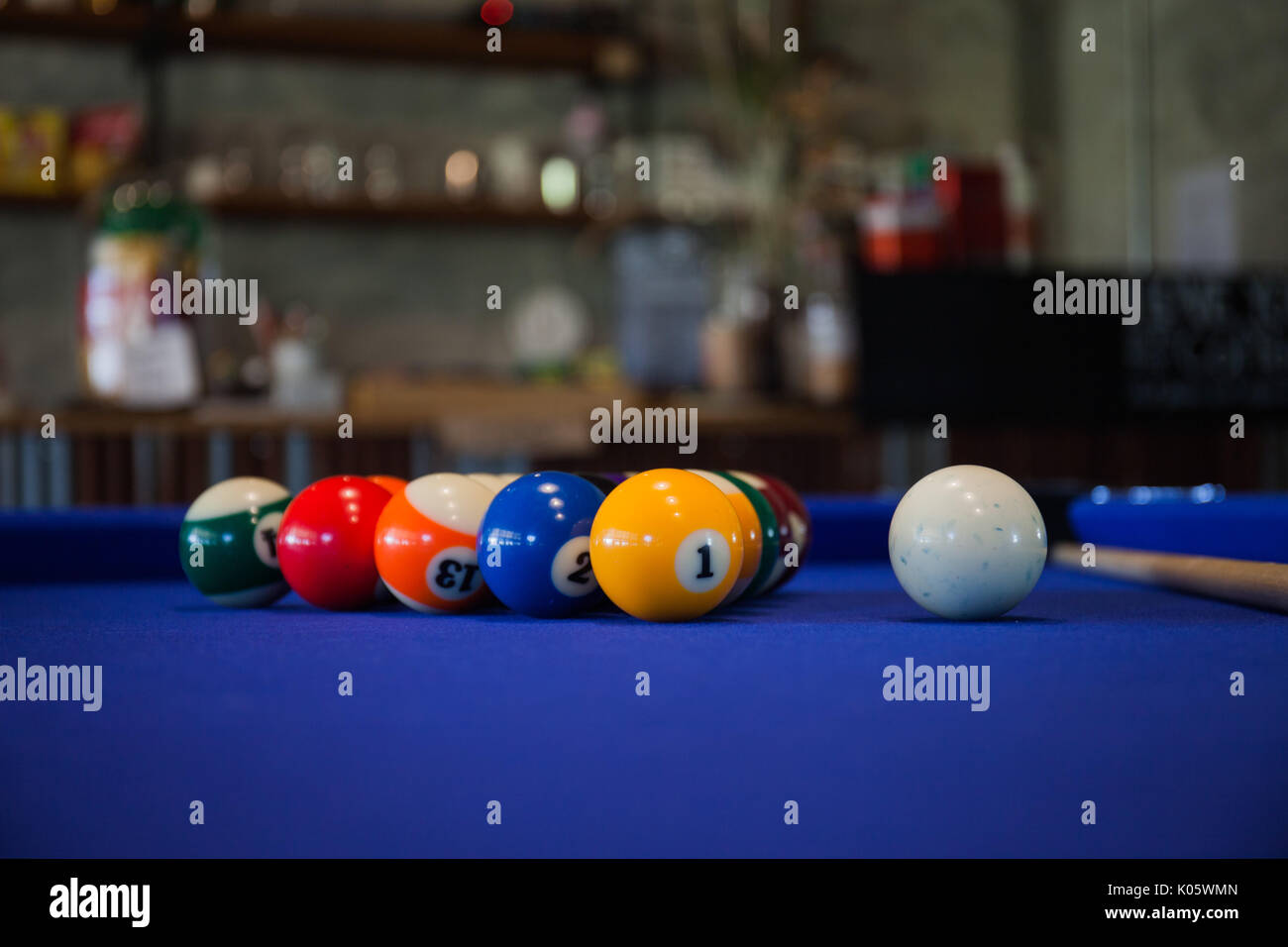 Billiard balls composition on blue pool table Stock Photo - Alamy