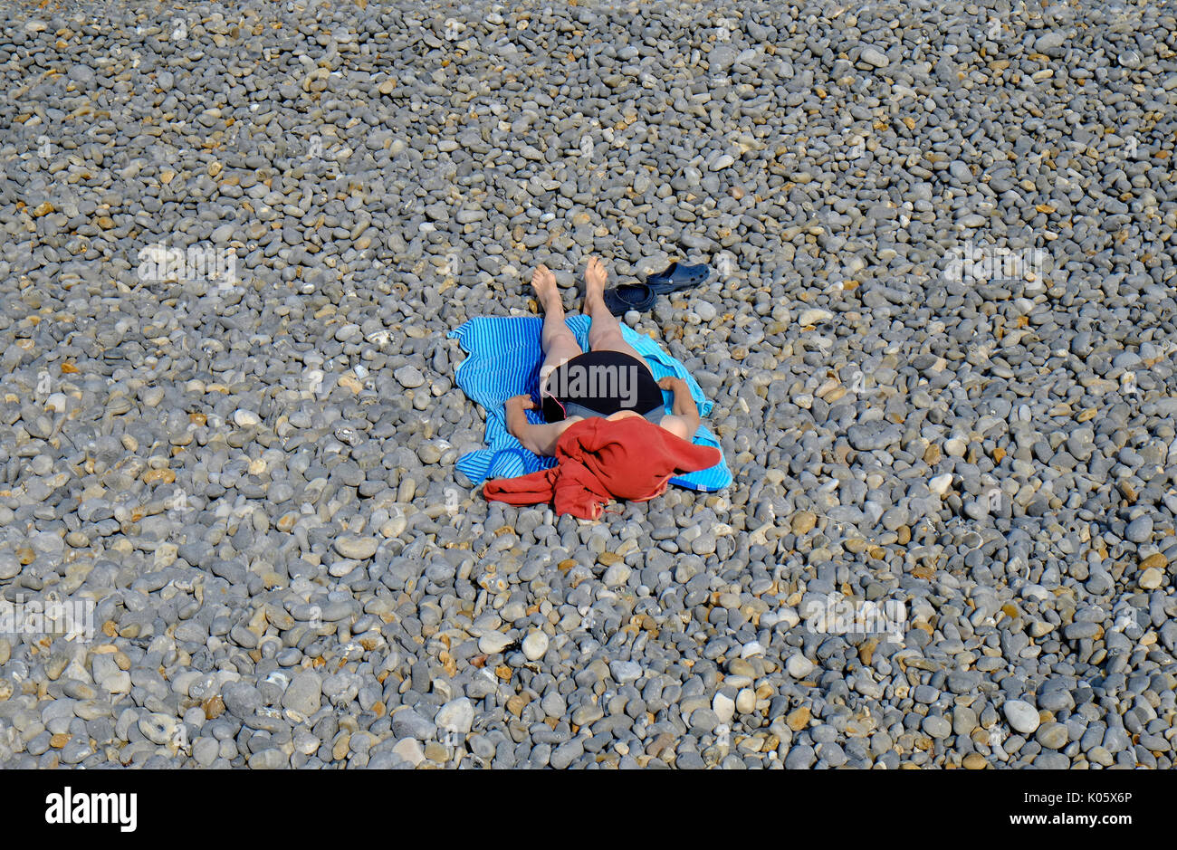 Mature british lady sunbathing beach hi-res stock photography and ...