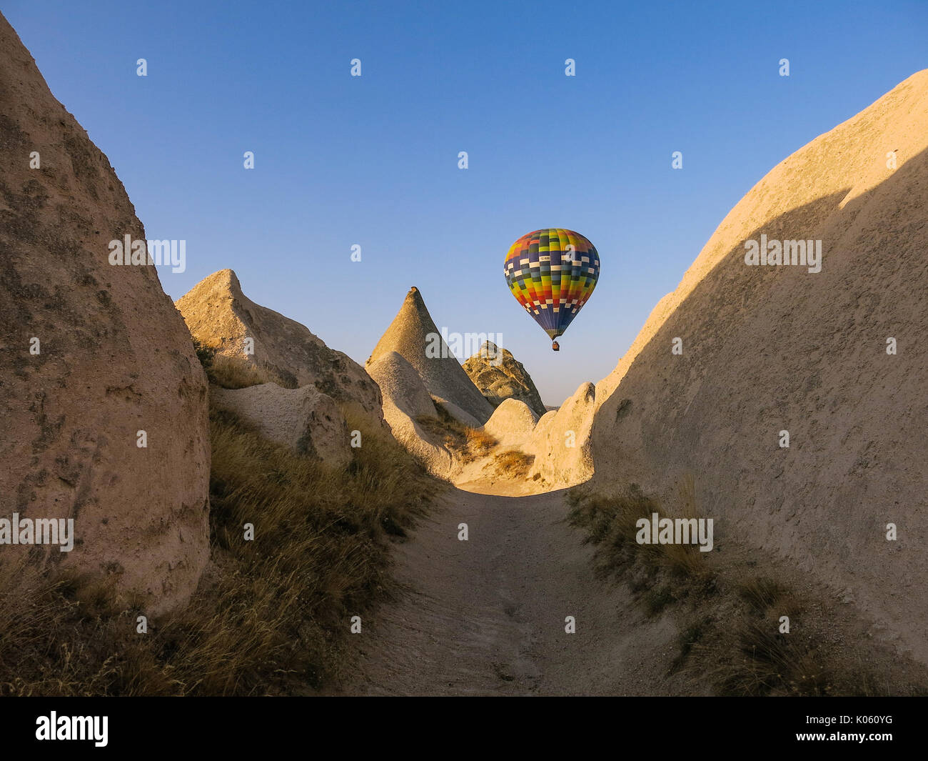 Hot air balloon over rock formations in Cappadocia Stock Photo - Alamy
