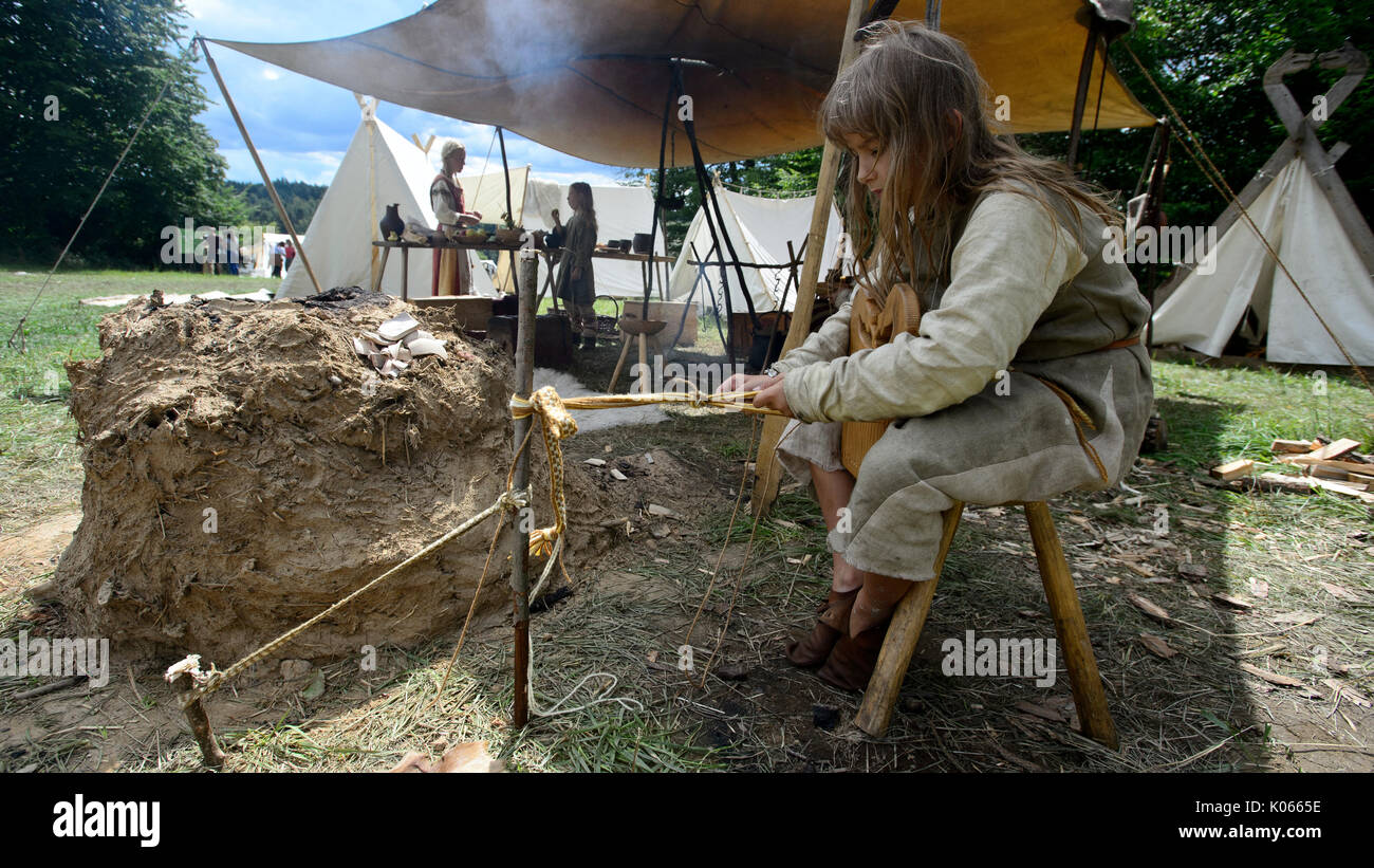 Residents of early medieval camp in historical costumes are seen in ...