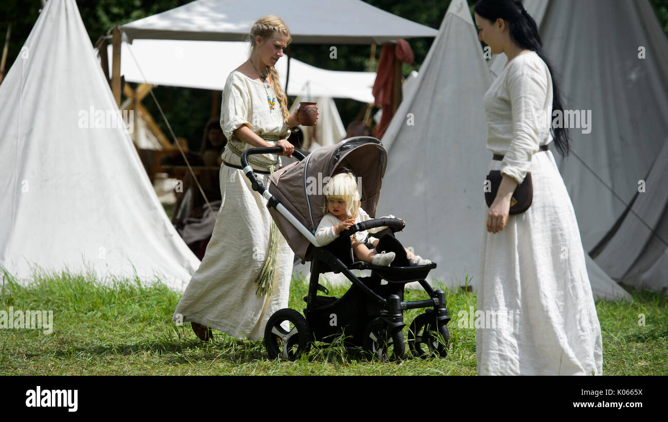 Residents of early medieval camp in historical costumes are seen in ...