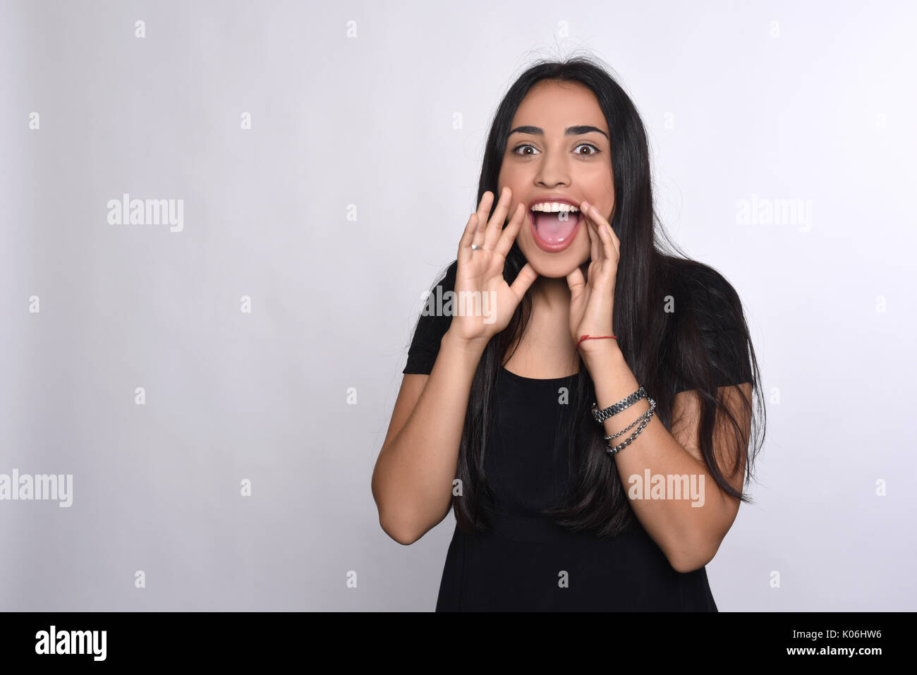 Beautiful young woman shouting and screaming. Isolated white background ...