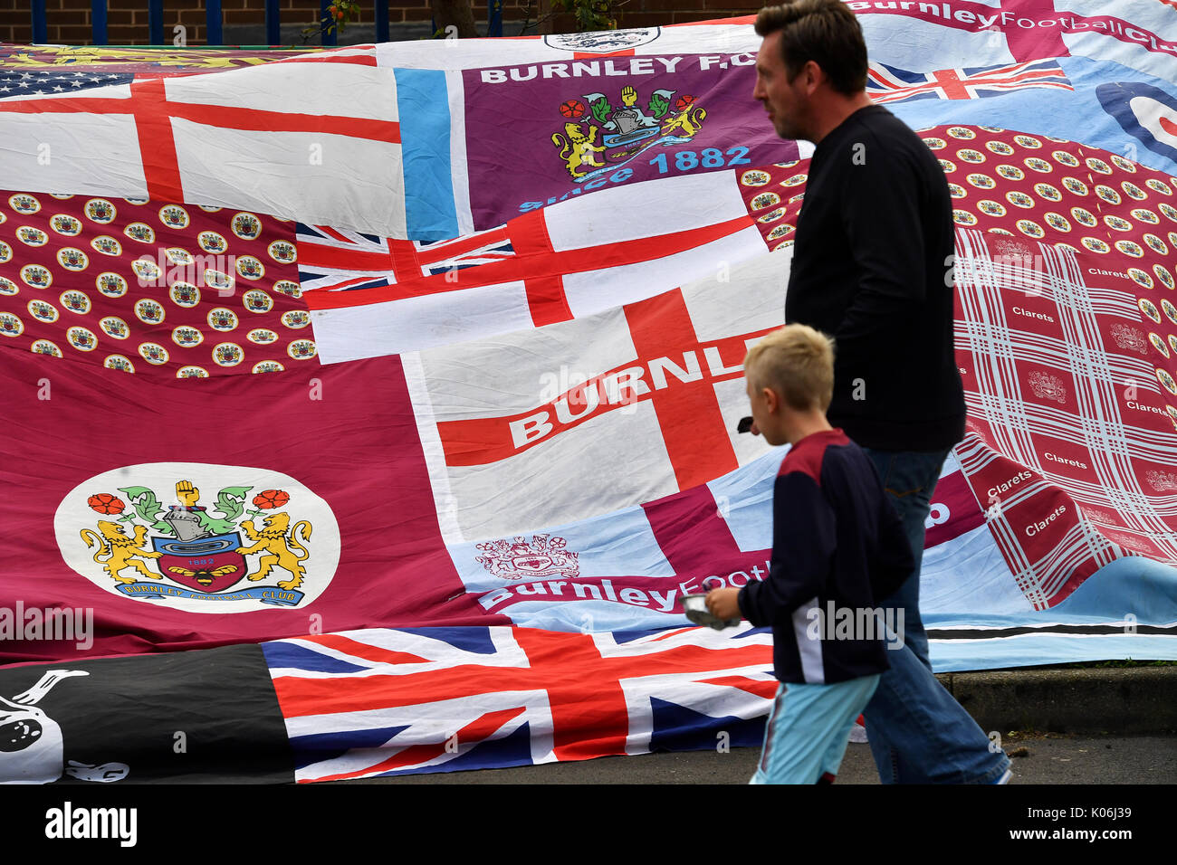 A fan walks past a large Burnley flag before the Premier League match ...