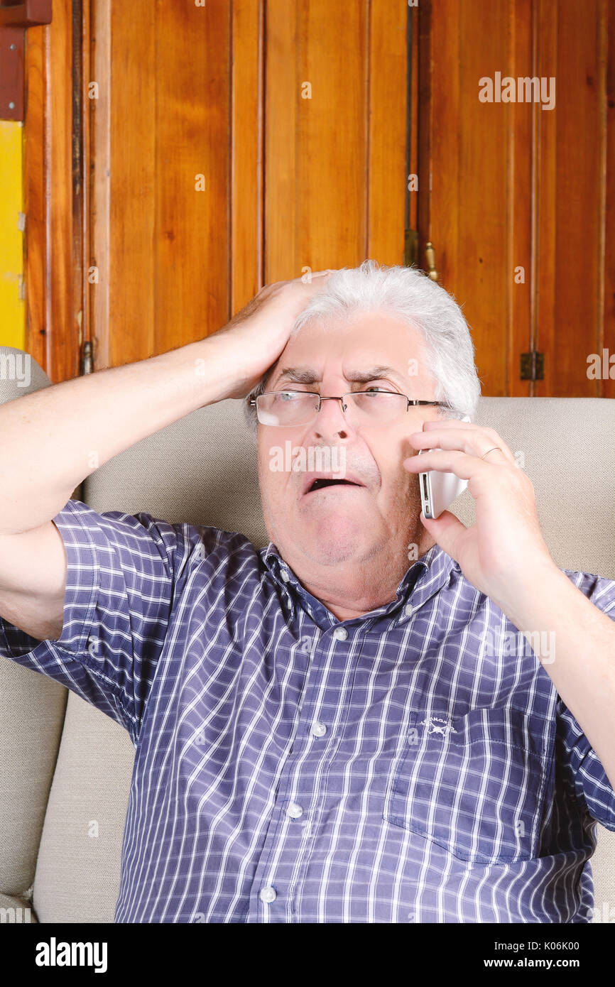 Portrait of an old man talking on the phone. Indoors Stock Photo - Alamy