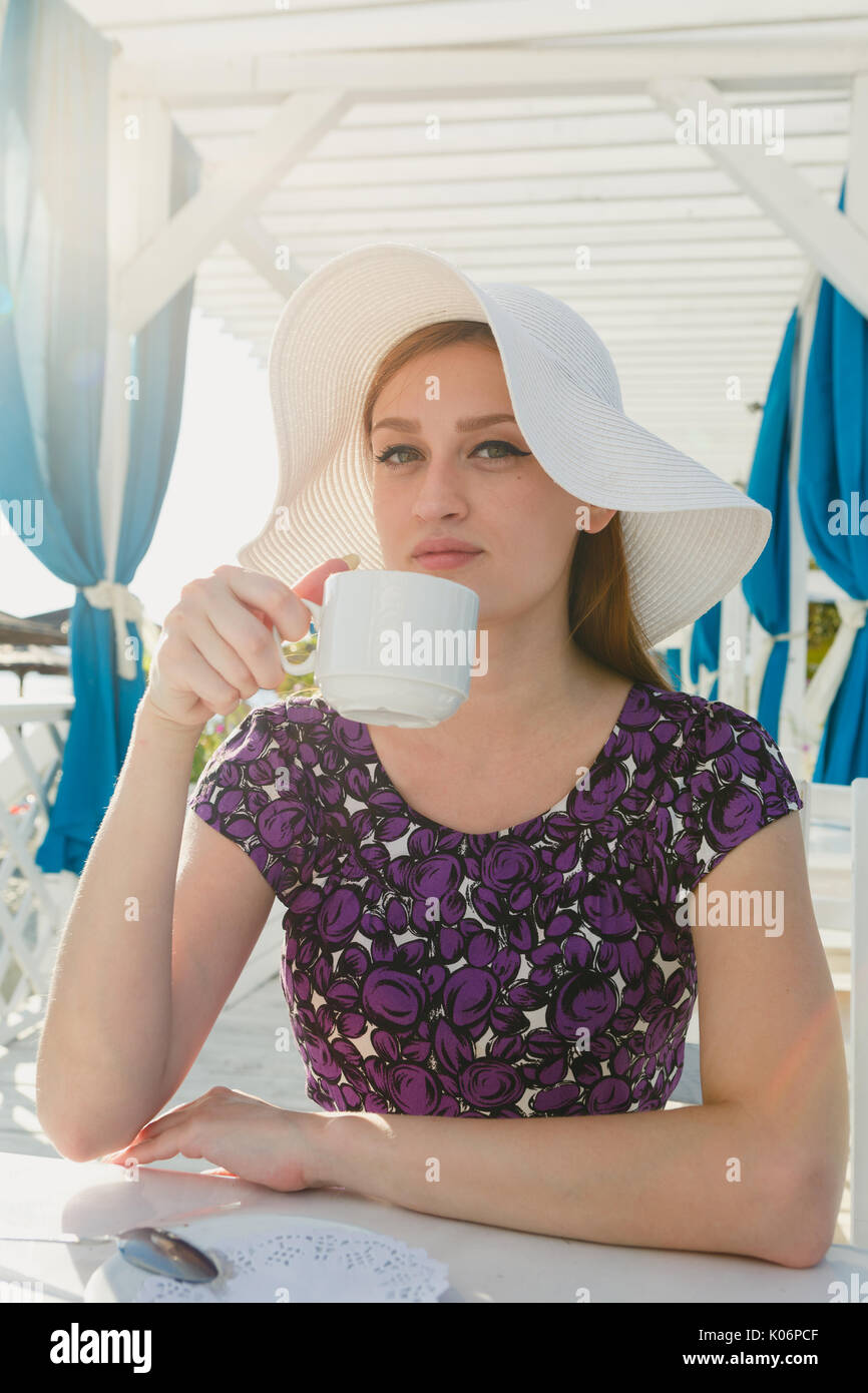Model in summer outfit drinking coffee Stock Photo - Alamy