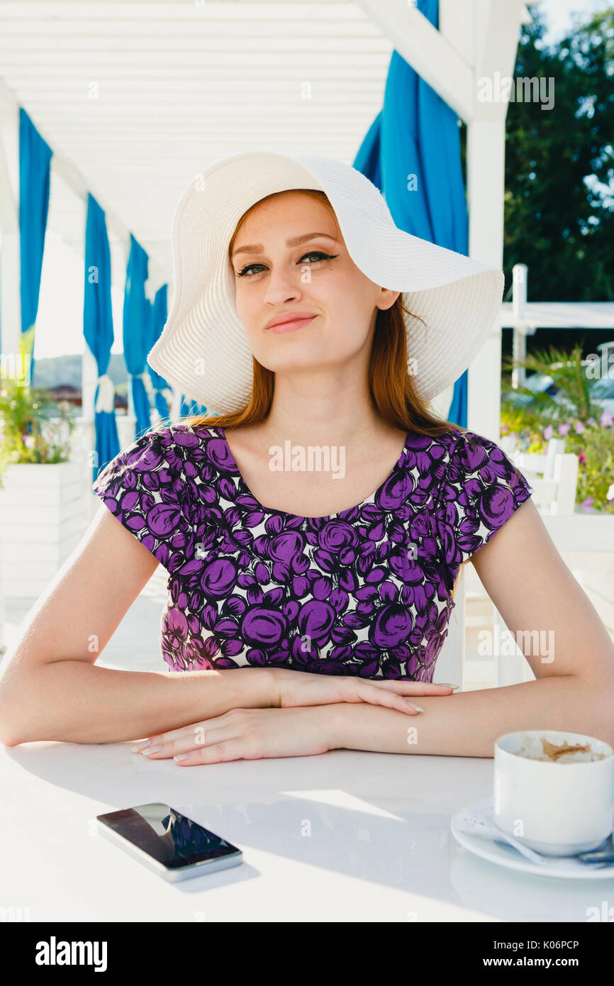 Content woman posing on resort terrace Stock Photo - Alamy
