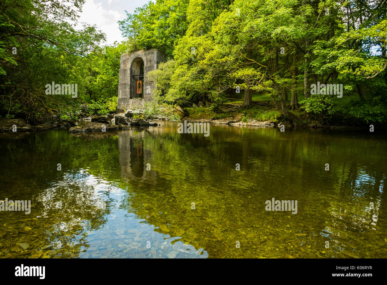 The remains of an old railway bridge over the river Wye near Rhayader ...