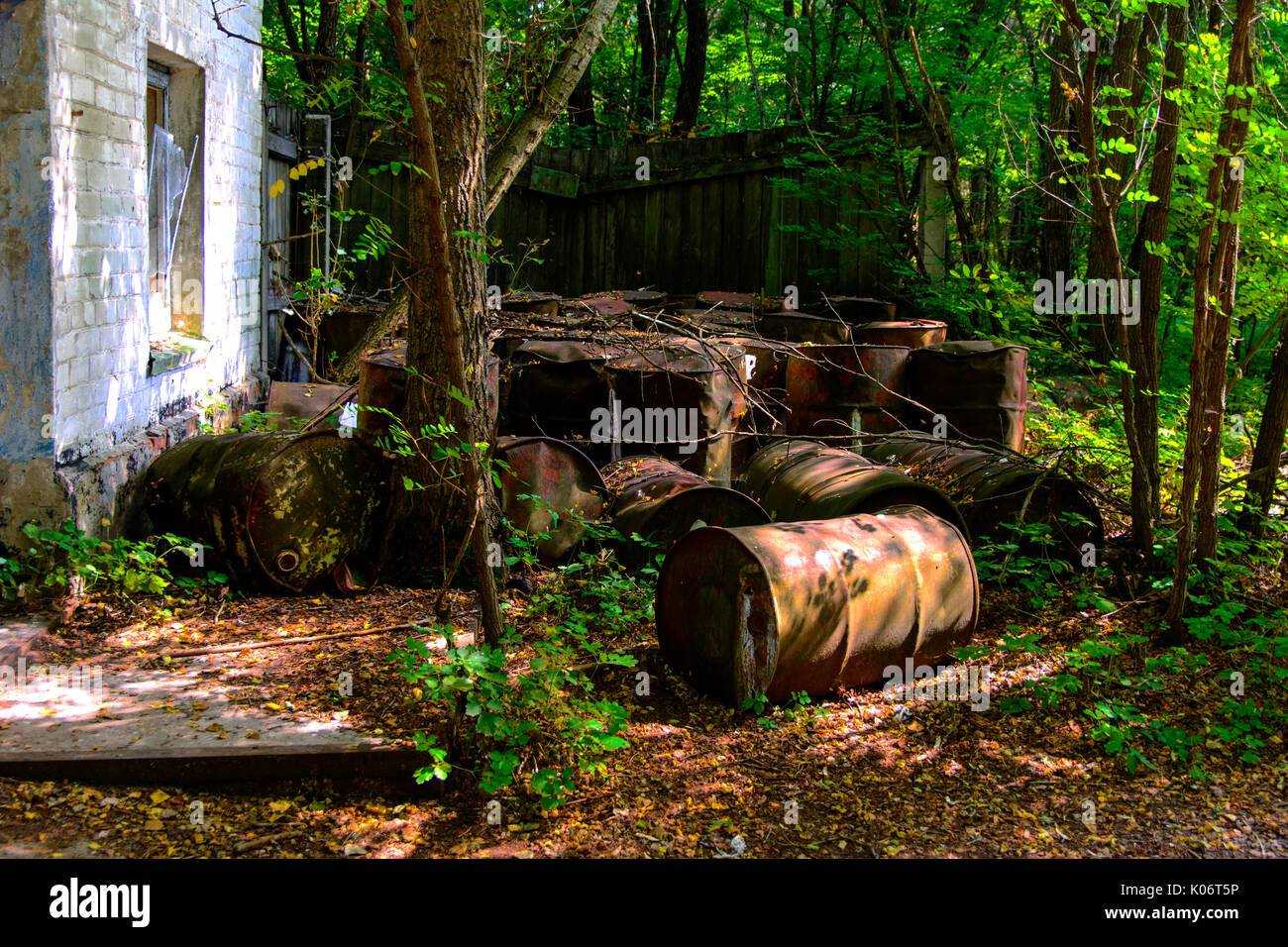 Old rusty barrels with radiation. Dead military unit. Consequences of ...