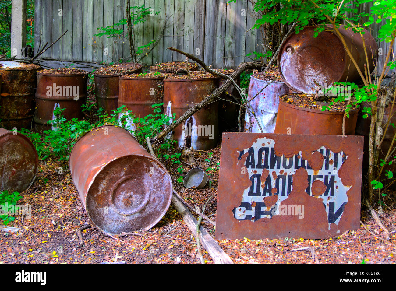Old rusty barrels with radiation. Dead military unit. Consequences of ...