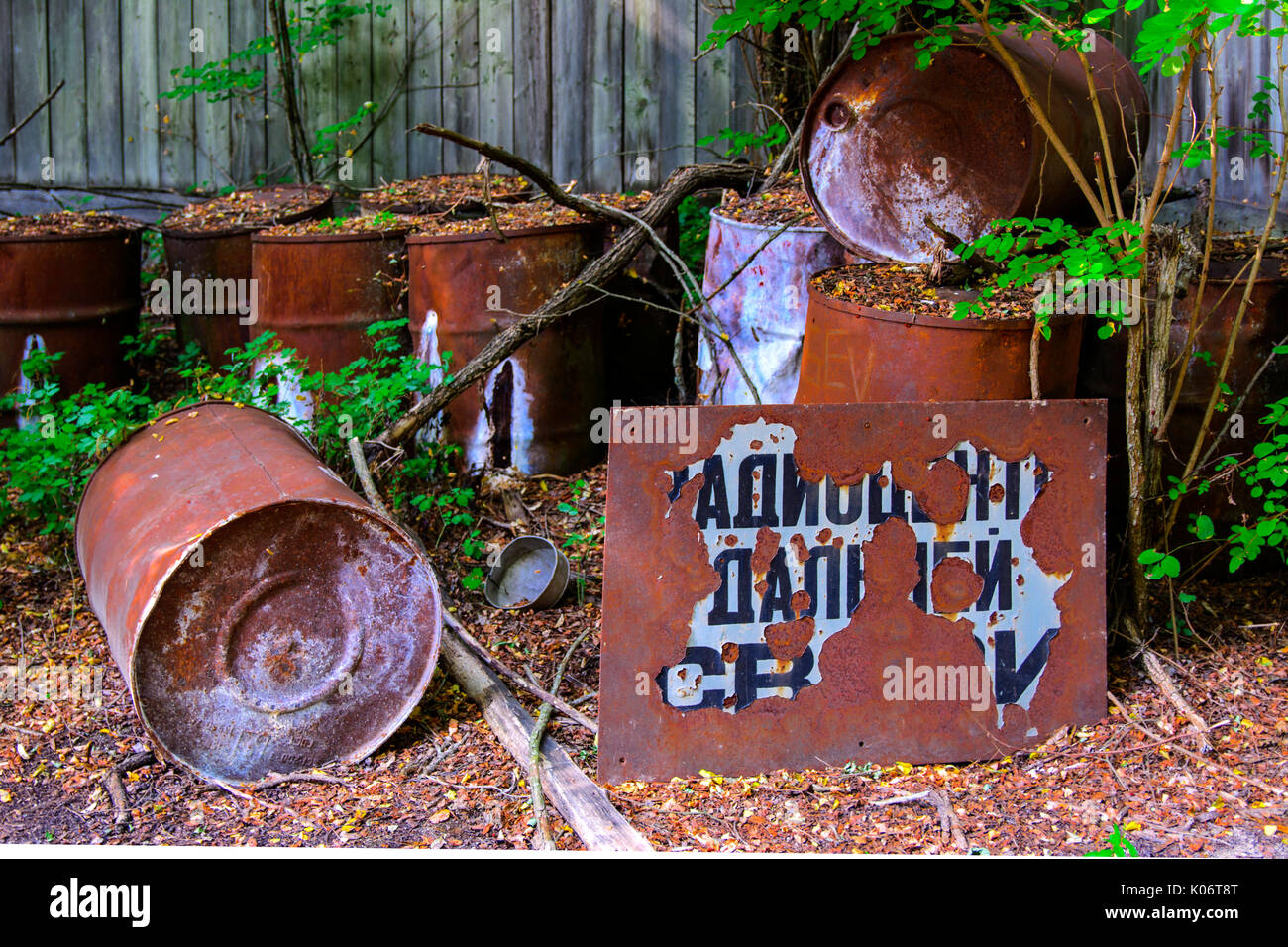 Old rusty barrels with radiation. Dead military unit. Consequences of ...