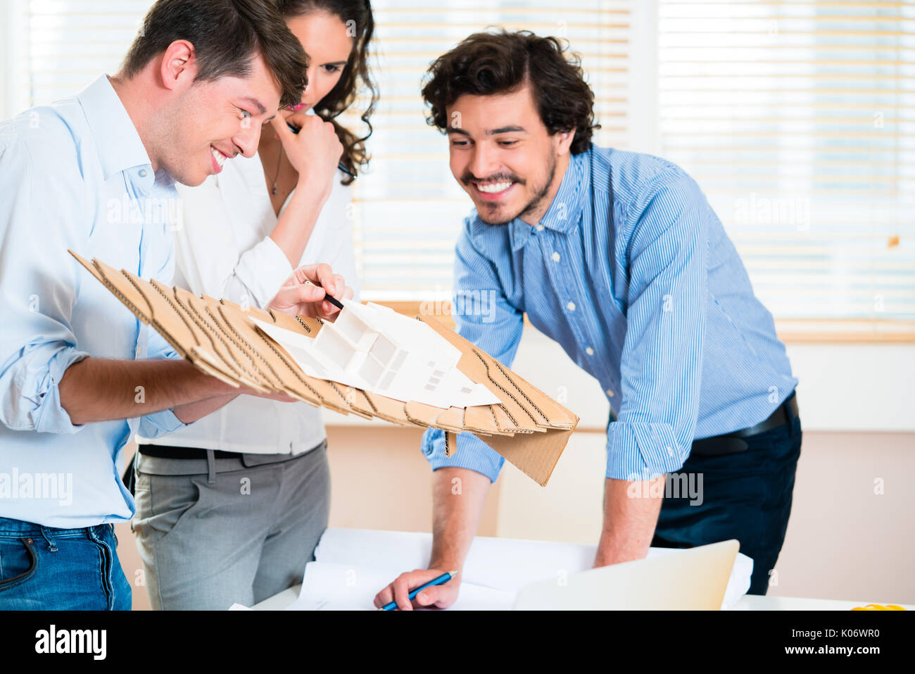 Architects present model of planned building Stock Photo - Alamy