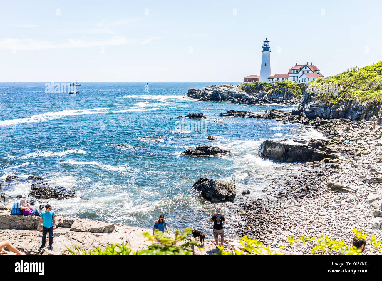 Cape Elizabeth, USA - June 10, 2017: People sitting on cliff rocks ...
