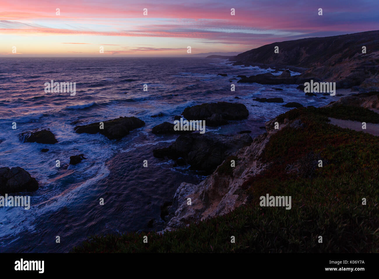 Colorful pacific ocean sunset viewed from hill on rocky coast Stock ...