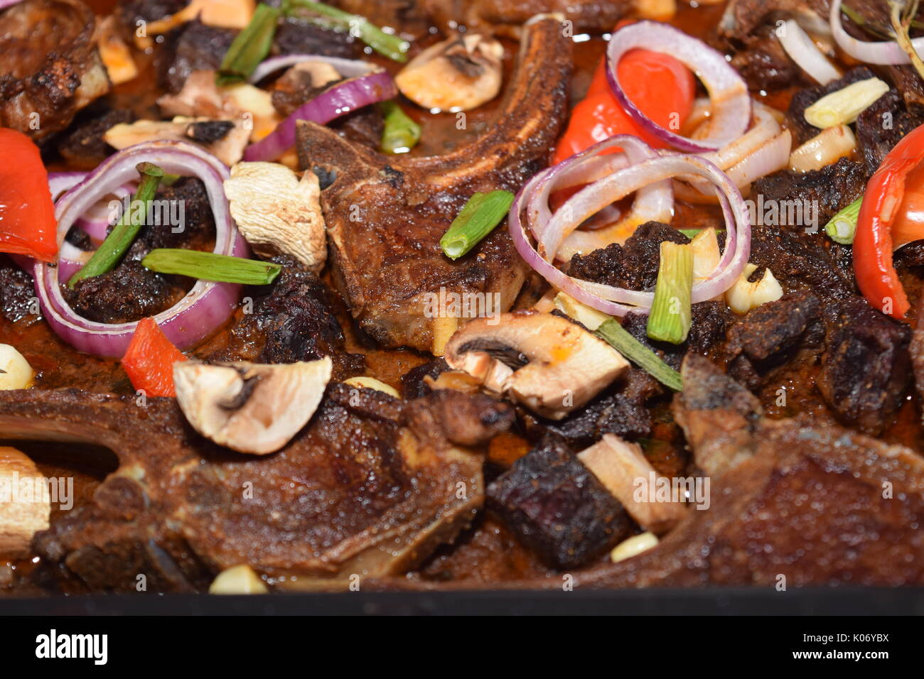Succulent cooked lamb chops in a tray Stock Photo - Alamy