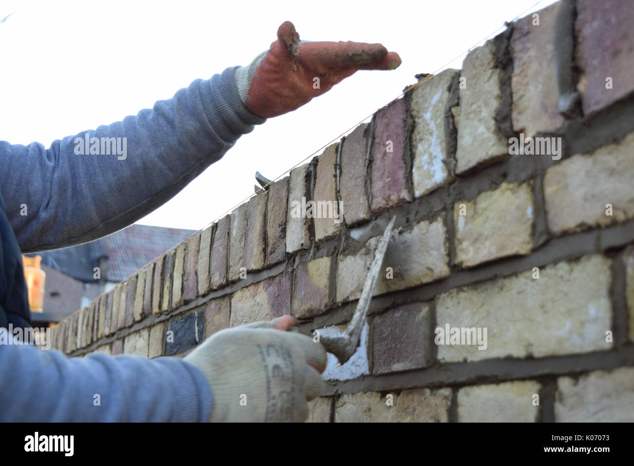 Male worker laying bricks Stock Photo - Alamy
