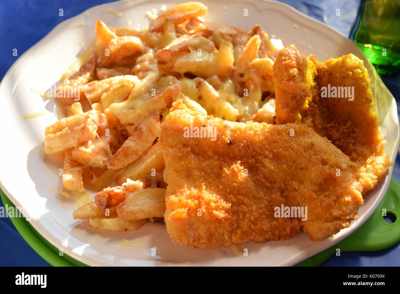 Cheesy chips and fried battered fish Stock Photo - Alamy