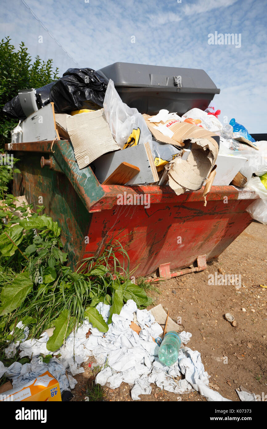 Overflowing rubbish skip hi-res stock photography and images - Alamy
