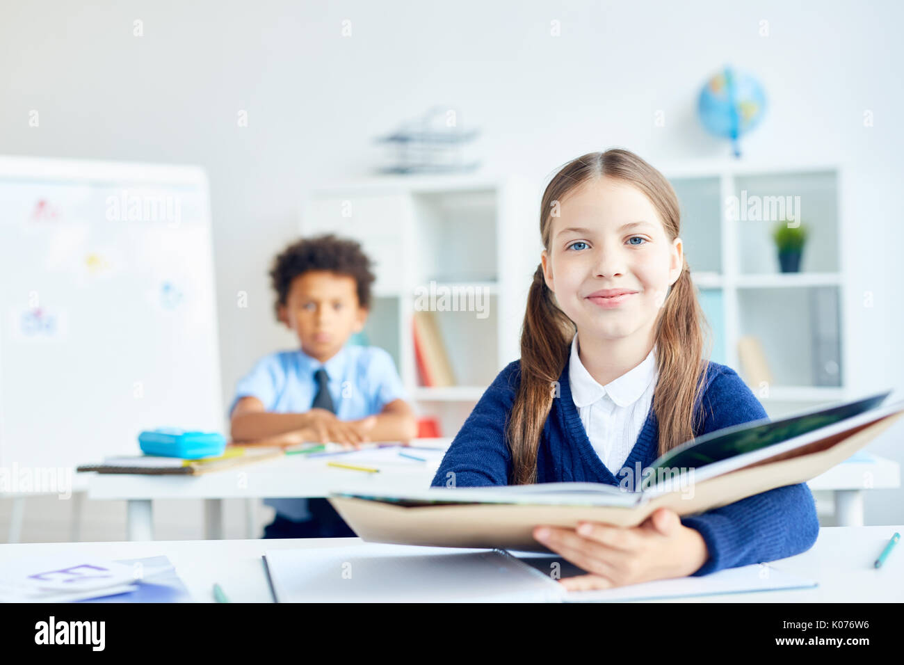 Kids at reading lesson Stock Photo - Alamy