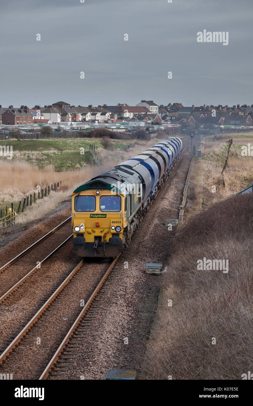 A Freightliner class 66 locomotive passes Cottam Marsh, Redcar with the ...