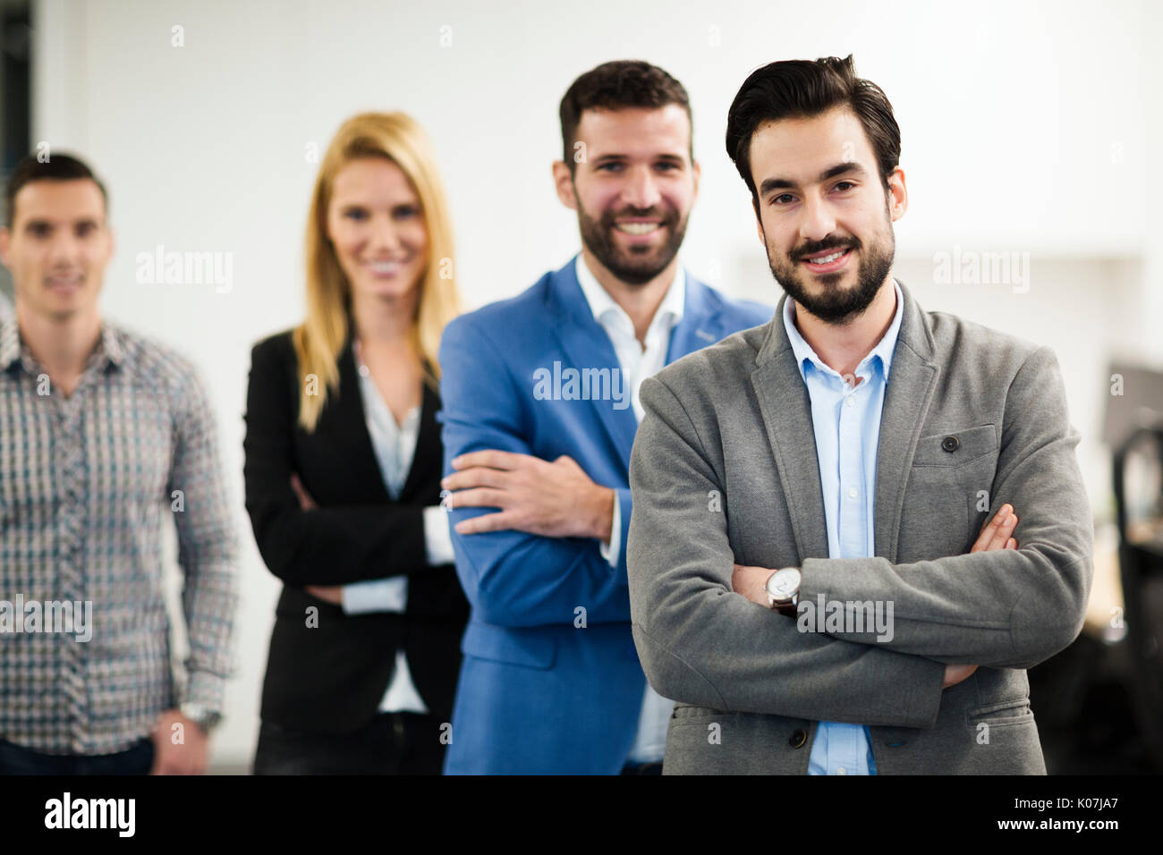 Team of cheerful businesspeople posing for group picture Stock Photo ...