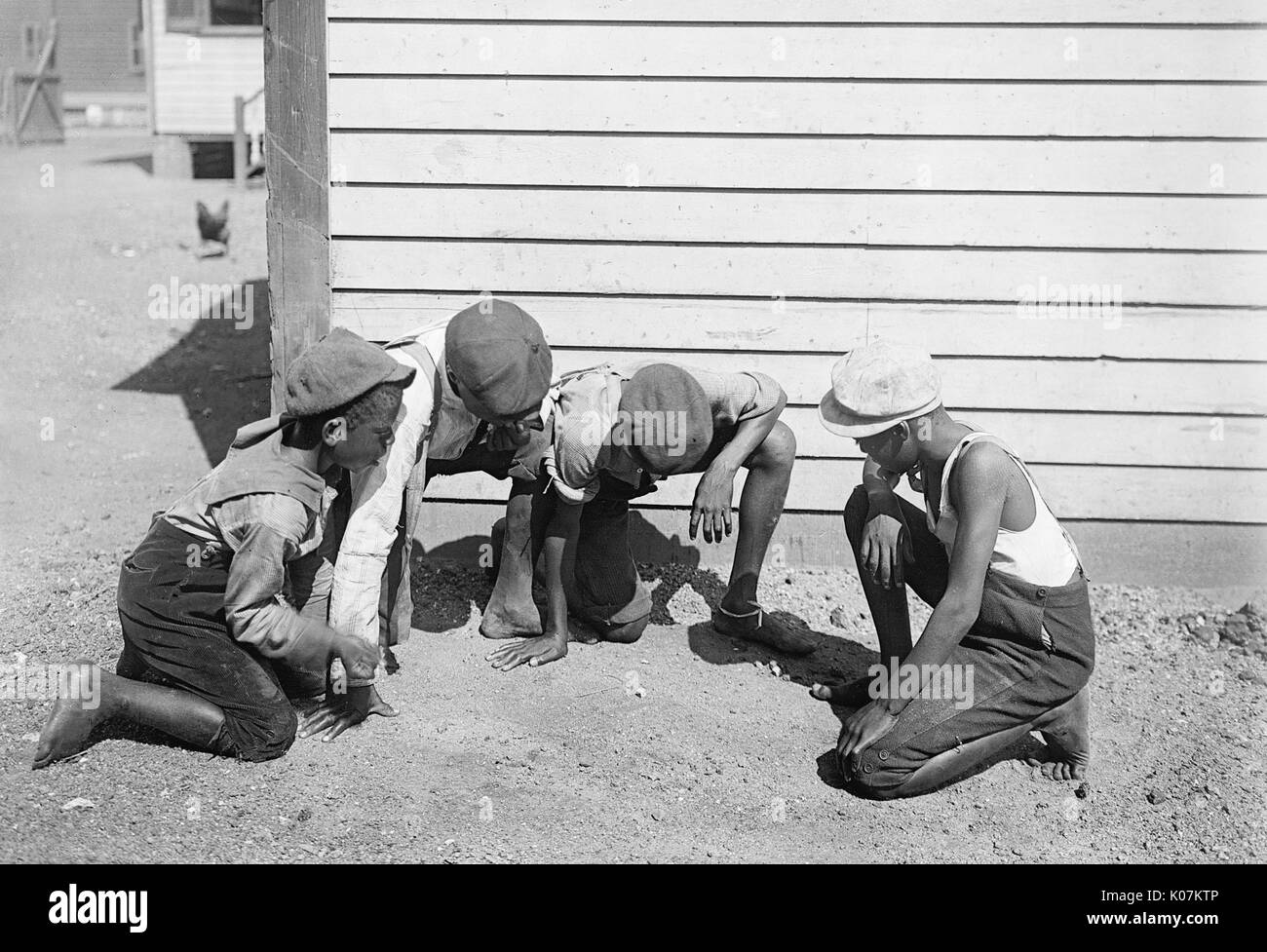 Four African American children playing a gambling game in America Date ...