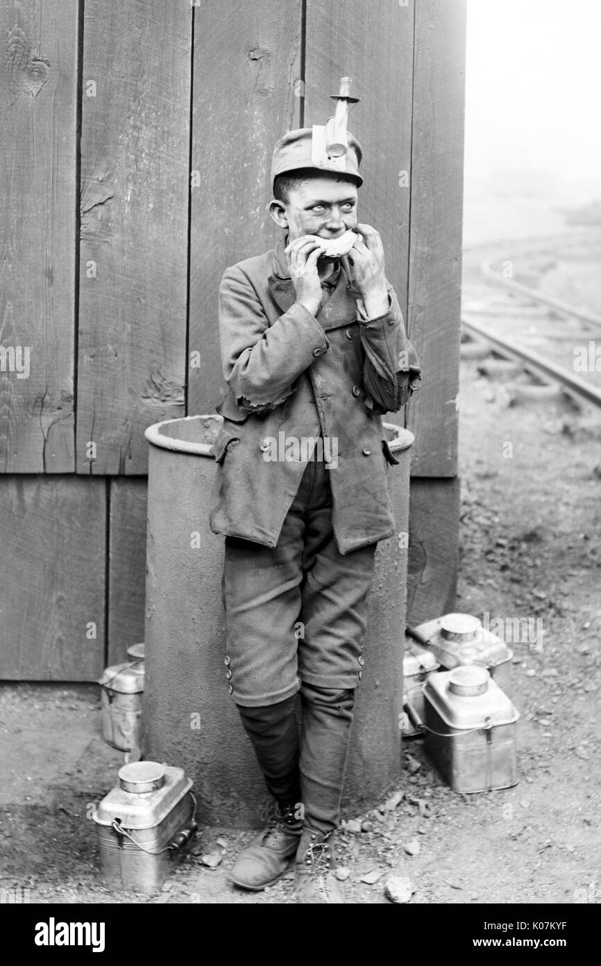 Breaker boy eating during a food break at a coal mine in Kin Stock ...