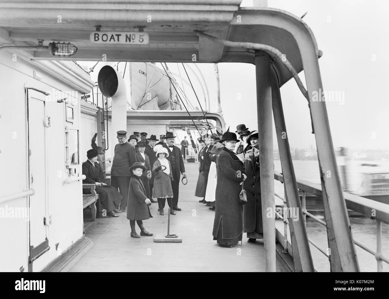 Passengers and children playing quoits on deck of Steamer Co Stock ...
