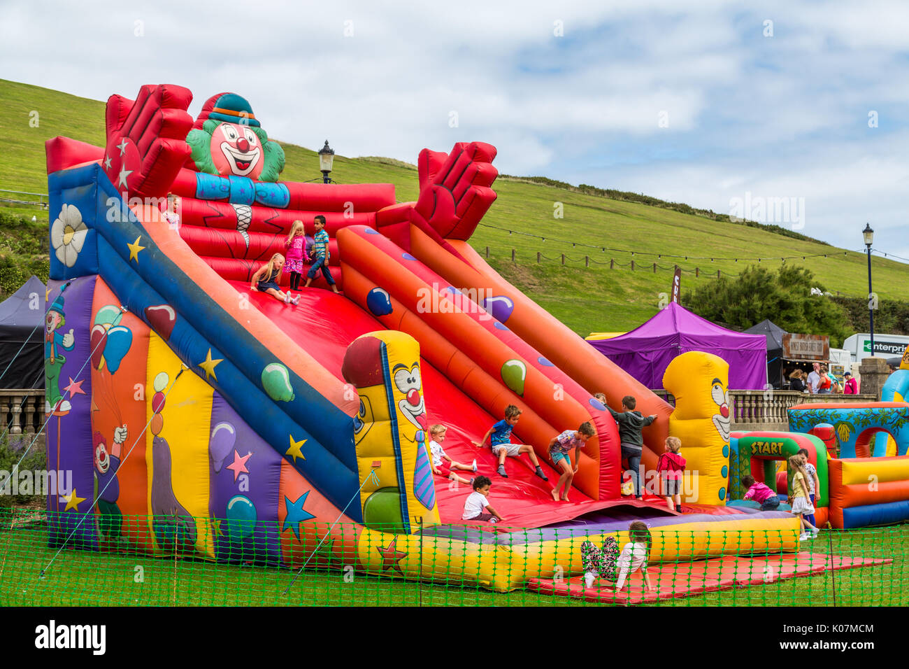 Children playing outdoors on a bouncy castle, England UK Stock Photo ...