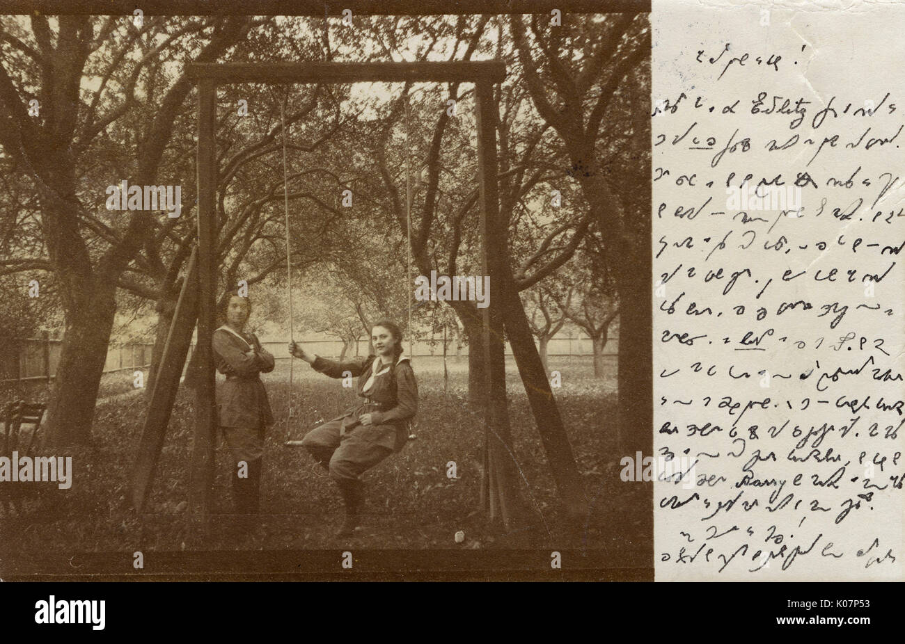 Two girl guides in uniform on a garden swing, Austria Stock Photo - Alamy