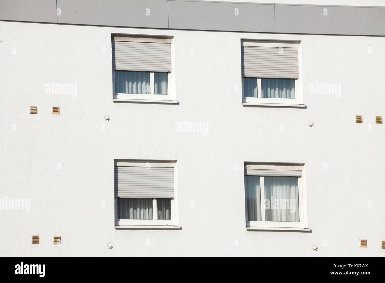 Windows with closed shutters on a white House Wall Stock Photo - Alamy