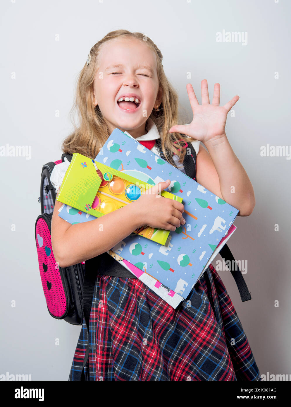 child in a school uniform with a backpack Stock Photo - Alamy