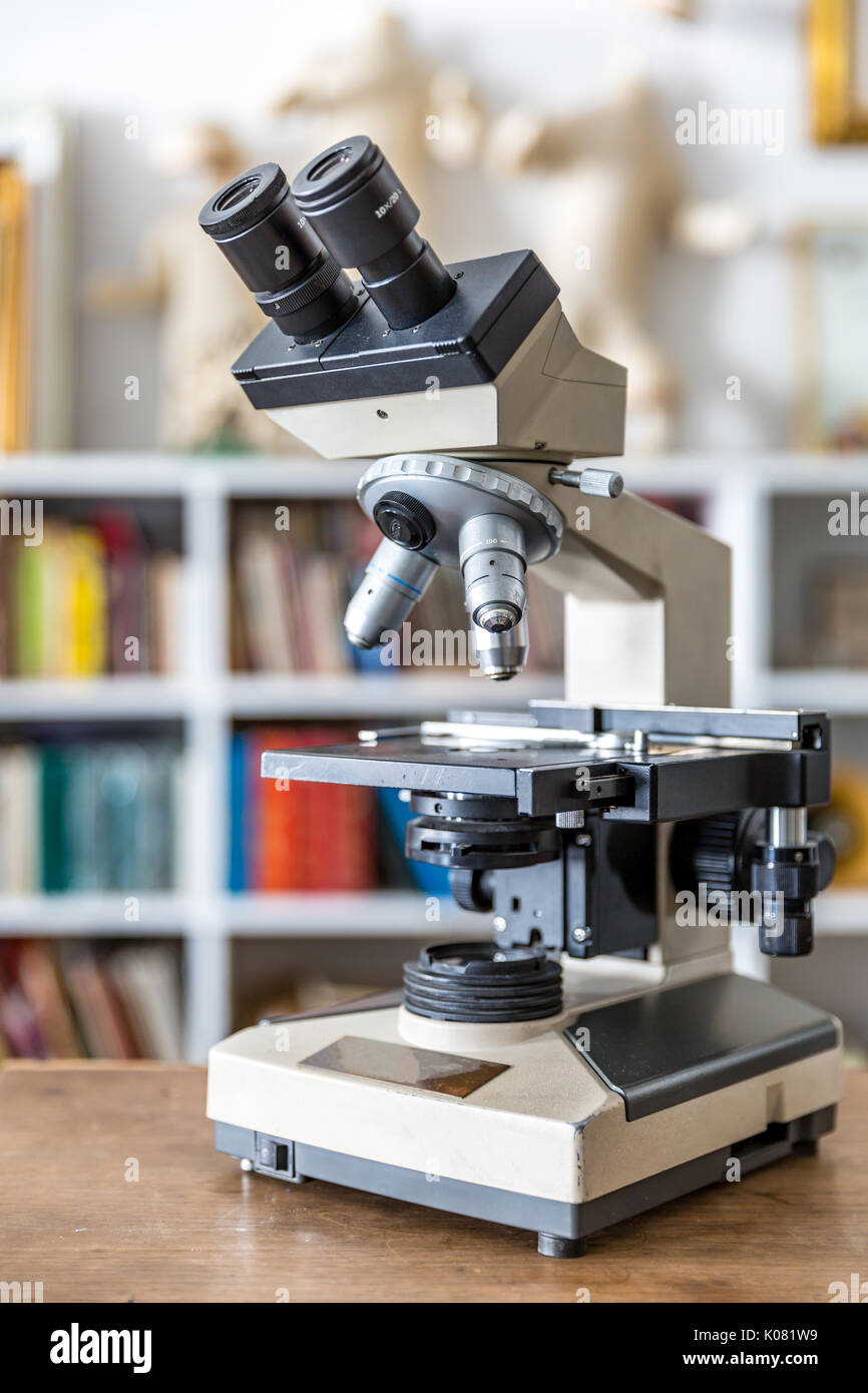 Microscope with education school background Stock Photo - Alamy