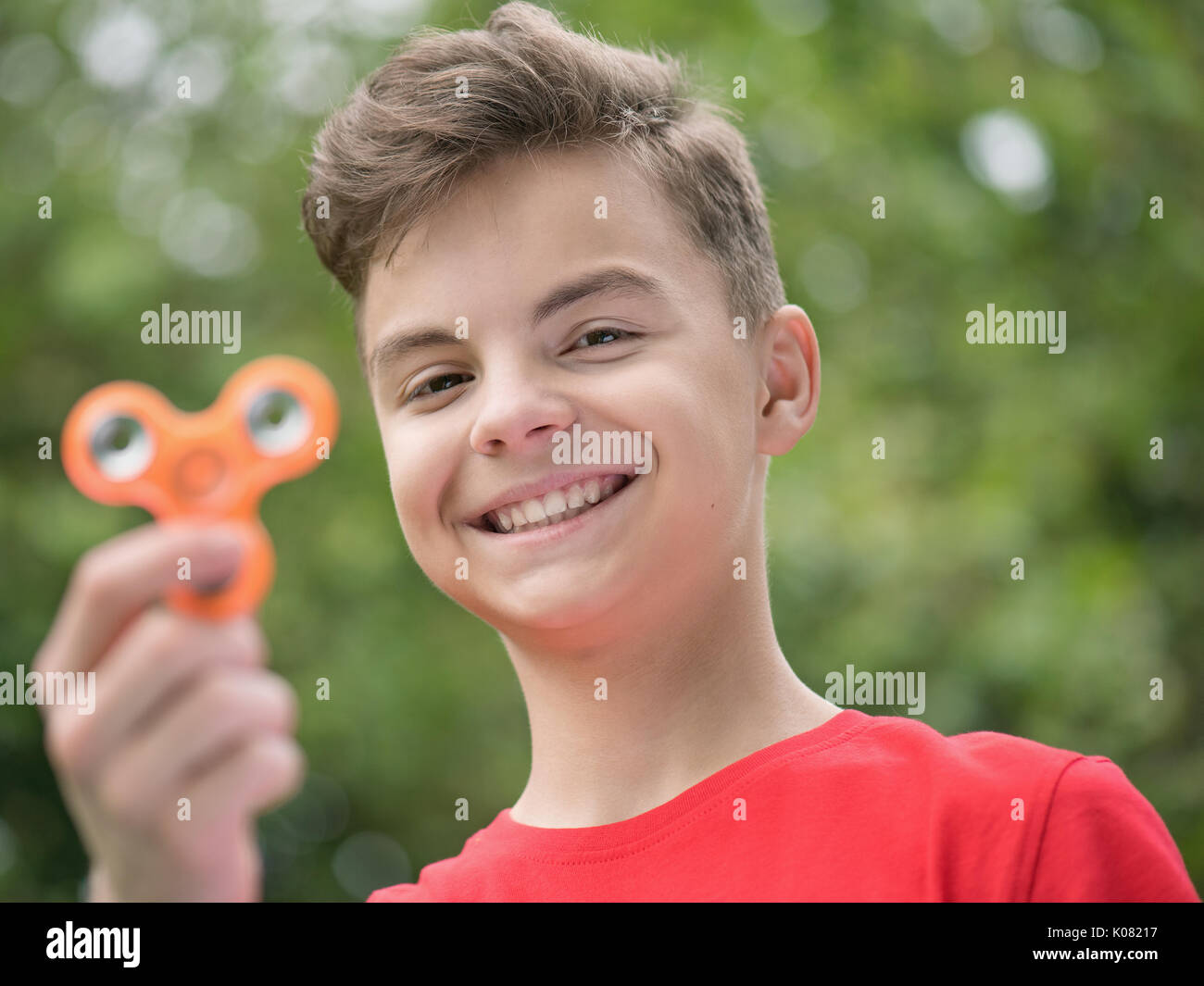 Teen boy with spinner Stock Photo - Alamy