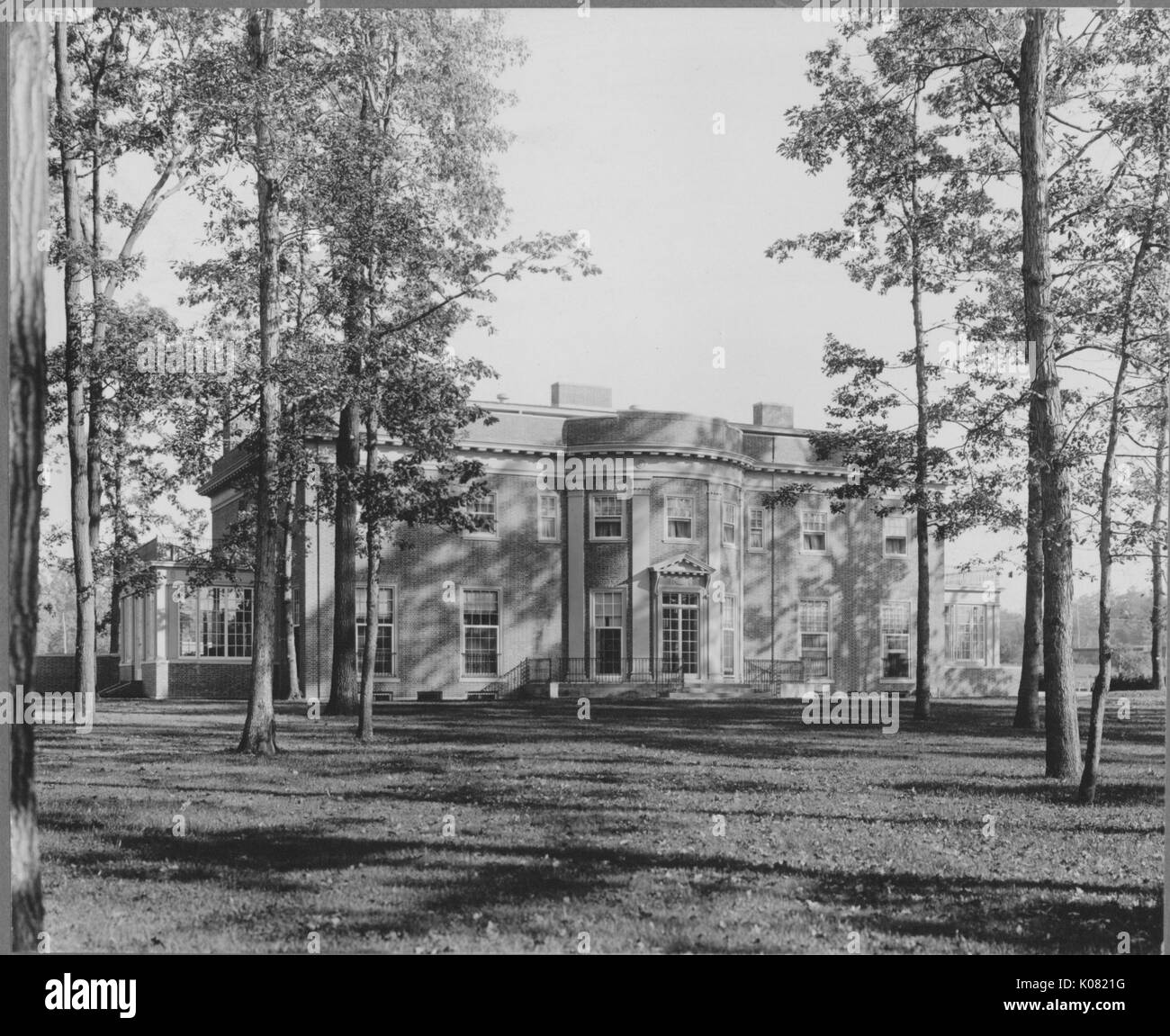 Photograph of a large two-story brick Roland Park in Baltimore, with a ...