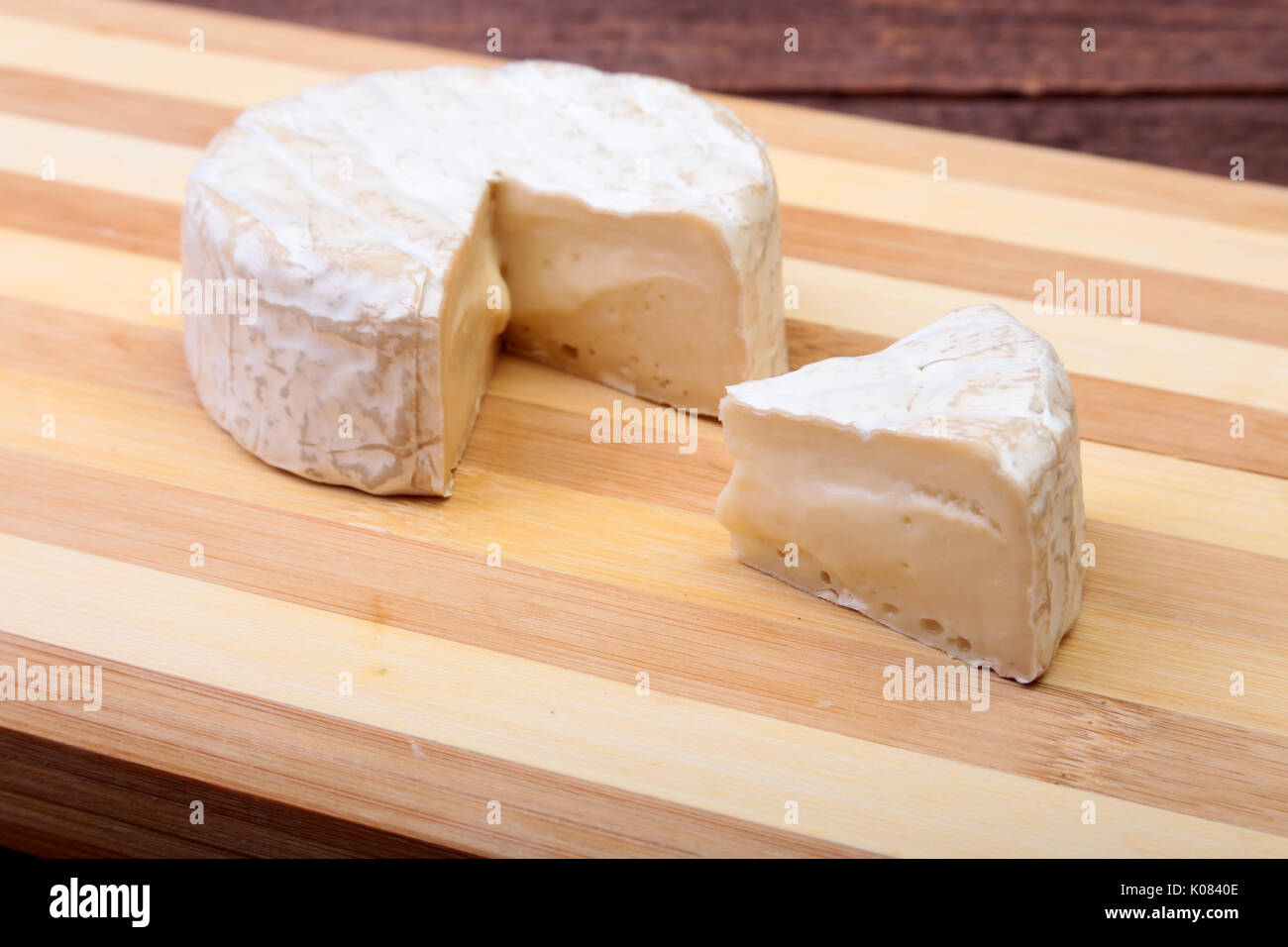 Cheese with white mold. Camembert or brie type on wood table. Healthy ...