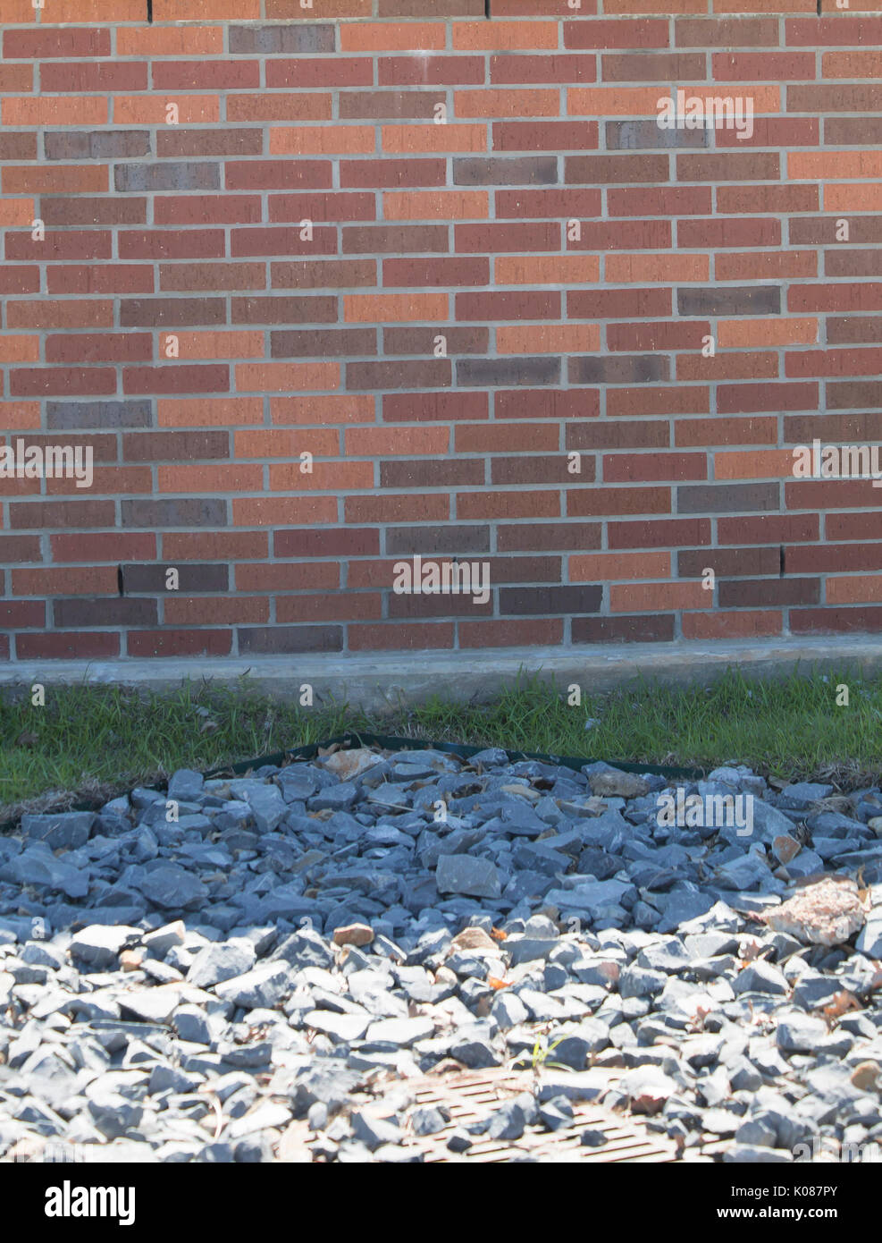 Short partition made of red and grey brick Stock Photo - Alamy