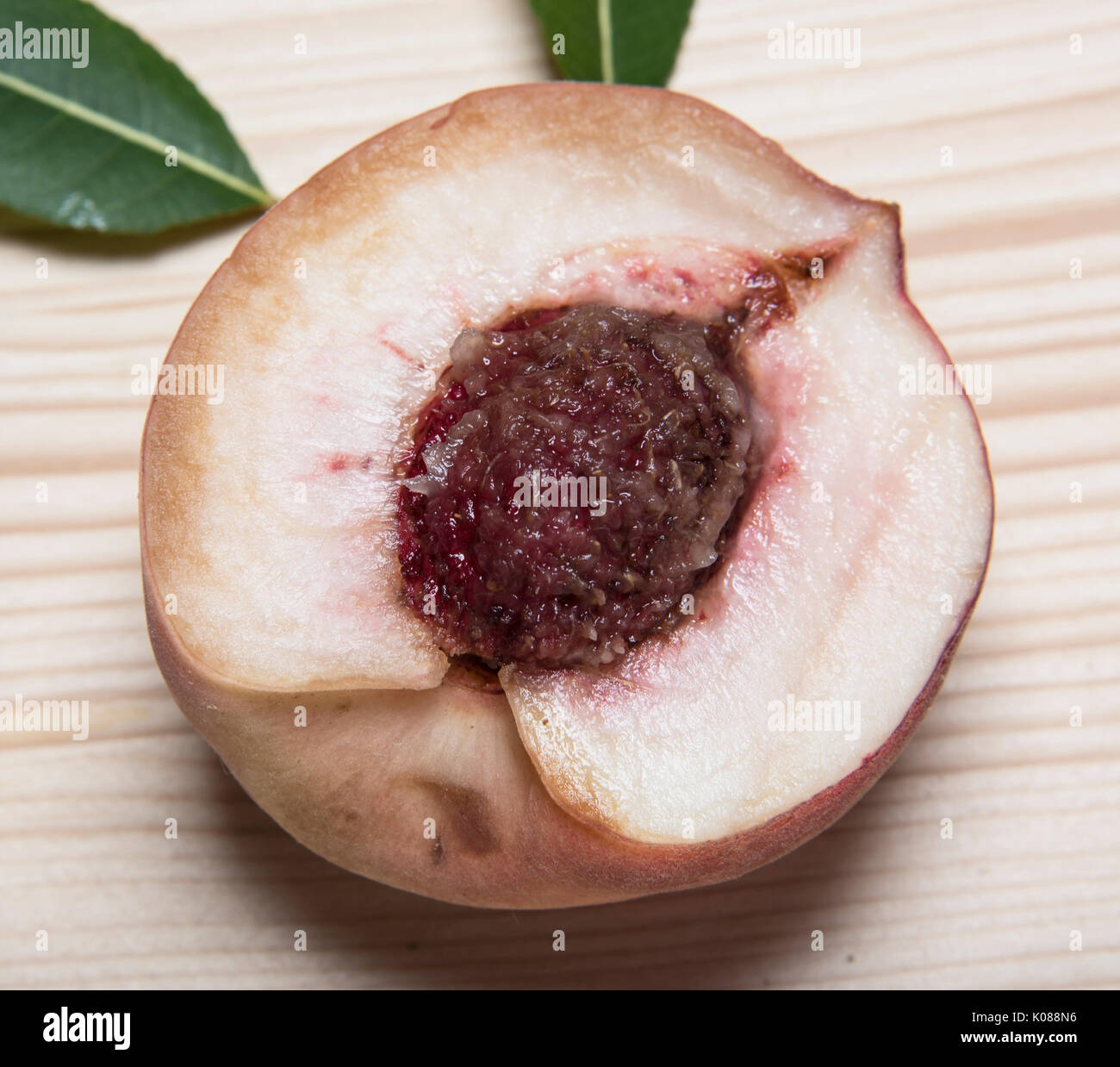 Peach half with bone. Peach stone Stock Photo - Alamy