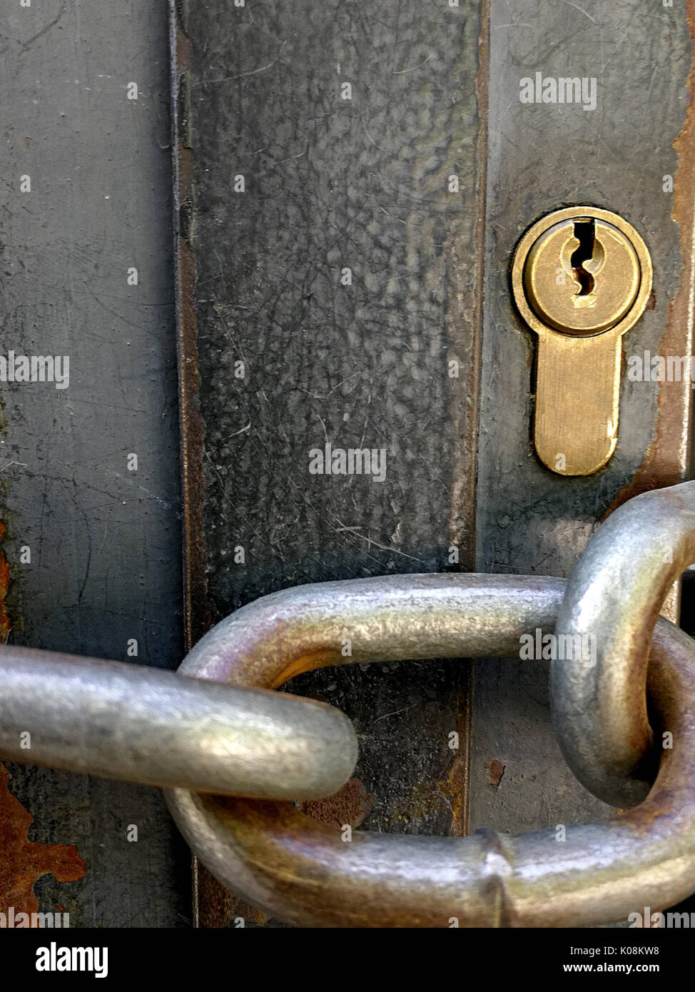 Key and chain closing door Stock Photo - Alamy