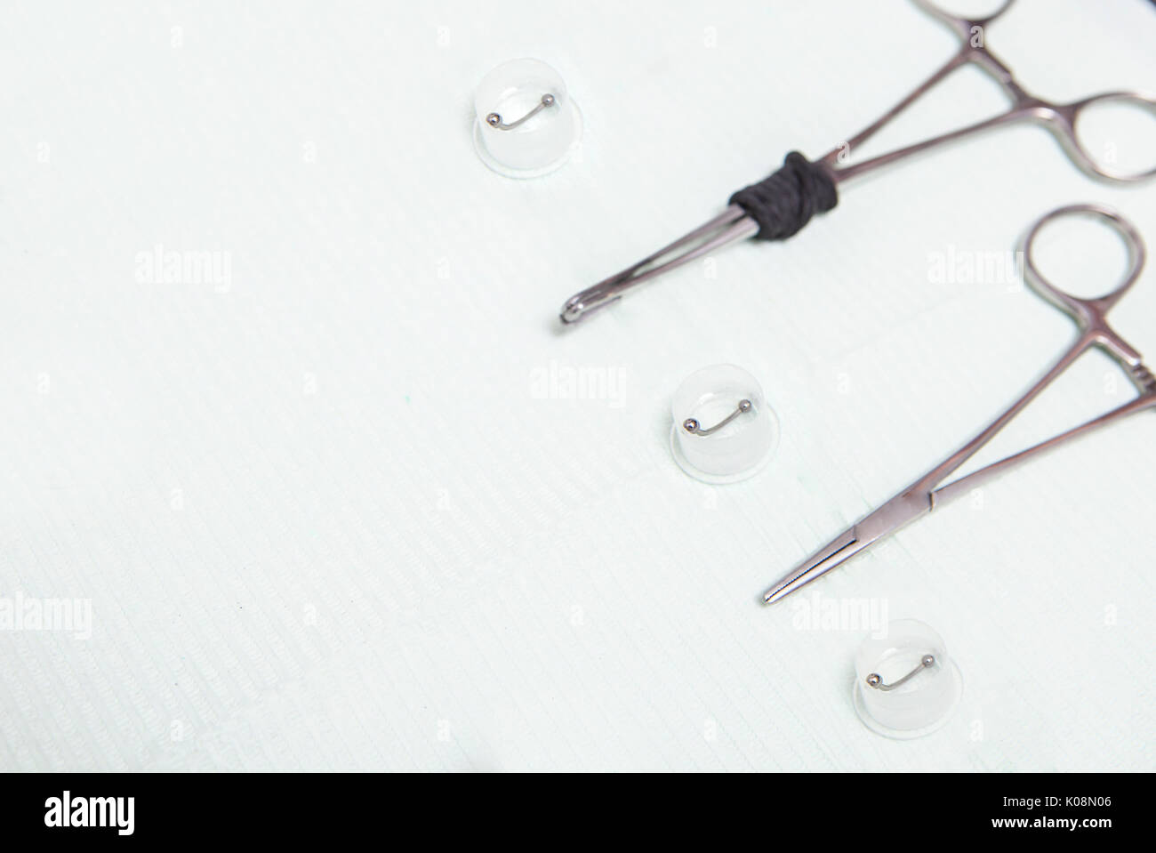 Piercing professional table with grips, forceps and jewels. Overhead ...