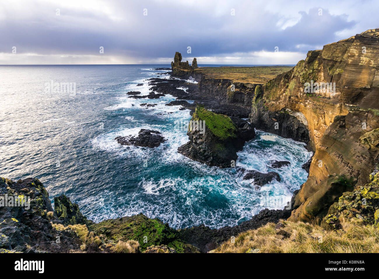 Bird rock and the sorrounding basalt cliffs. Londrangar, Snaefellsness ...