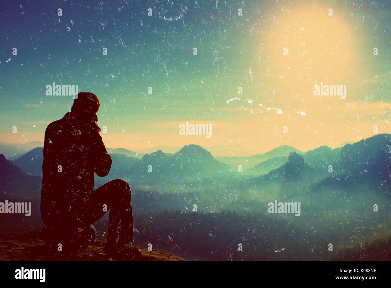 Film grain effect. Photographer takes photos with mirror camera on peak ...