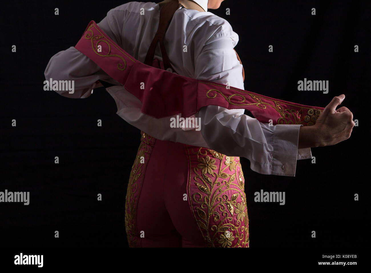 Woman bullfighter by dressing with vest on your back on a black ...