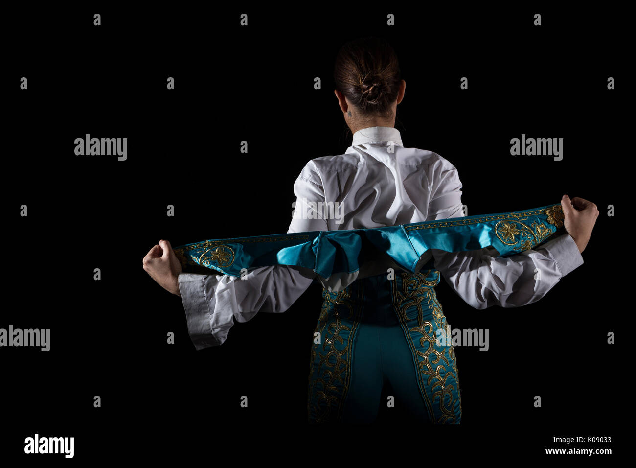 Woman bullfighter by dressing with vest on your back on a black ...