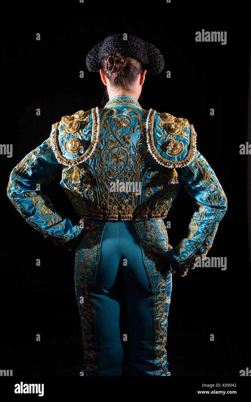 Woman bullfighter with blue costume back on black background Stock ...