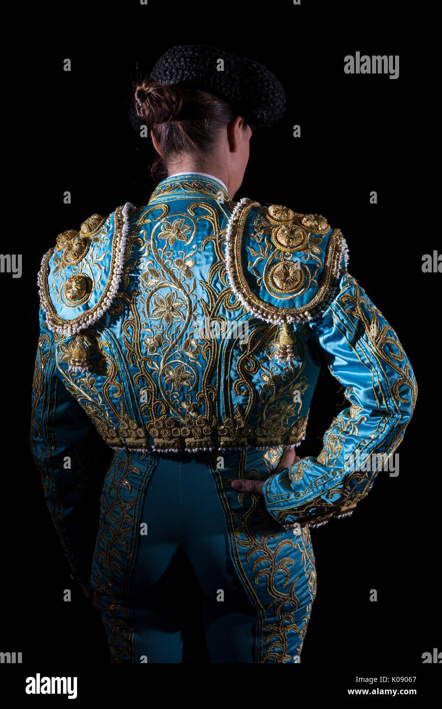 Woman bullfighter with blue costume back on black background Stock ...